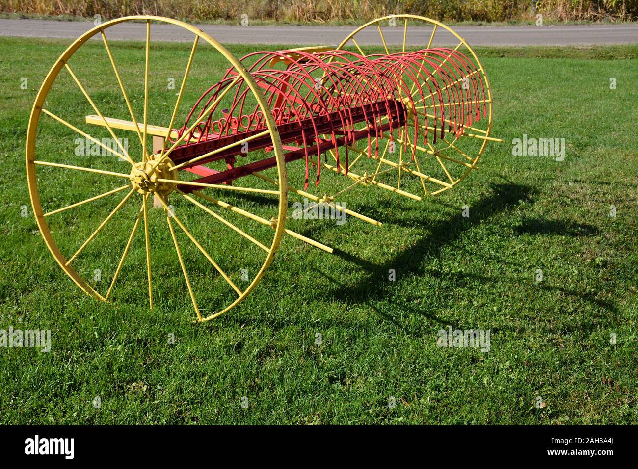 Refurbished red and yellow farm machinery Stock Photo - Alamy