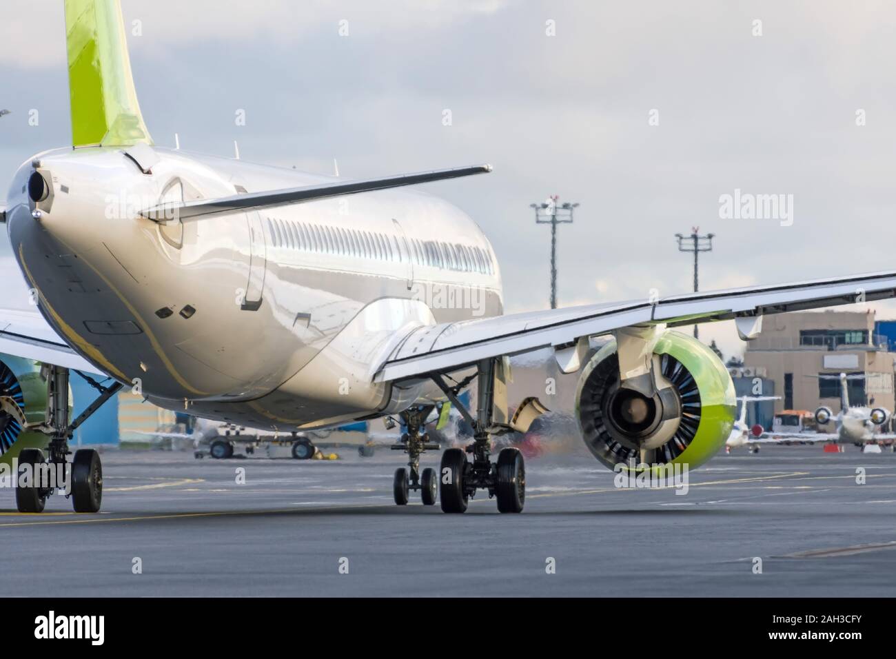 Commercial jet airplane taxiing on the runway, back view Stock Photo ...