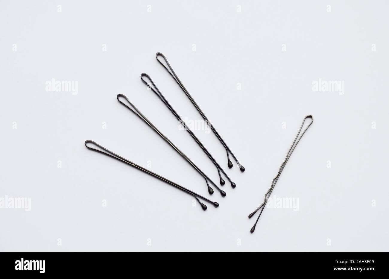 black iron hairpin arranged on white background Stock Photo - Alamy