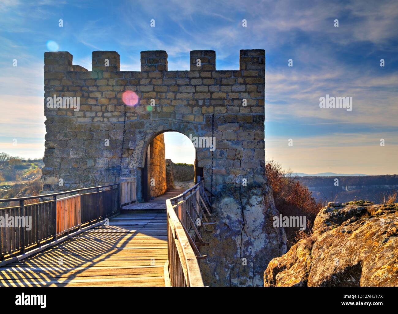 Beautiful view with wooden bridge leading to a stone gate of an ancient ...