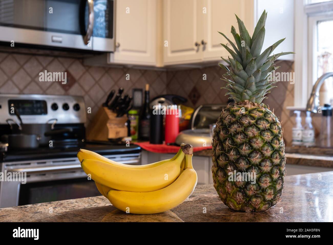 Interior of a kitchen with a bunch of bananas and pineapple on the ...