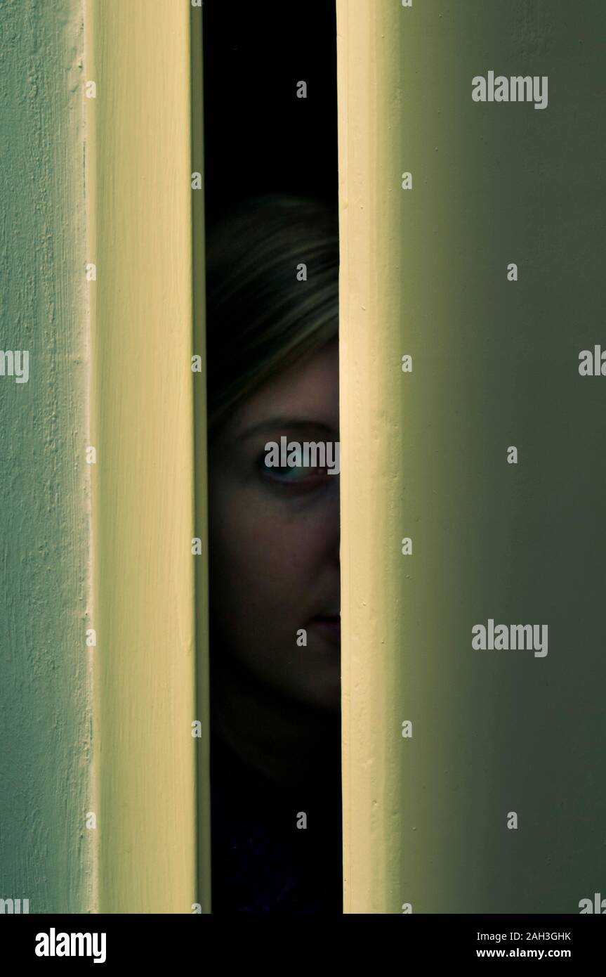 Girl peeking door hi-res stock photography and images - Alamy