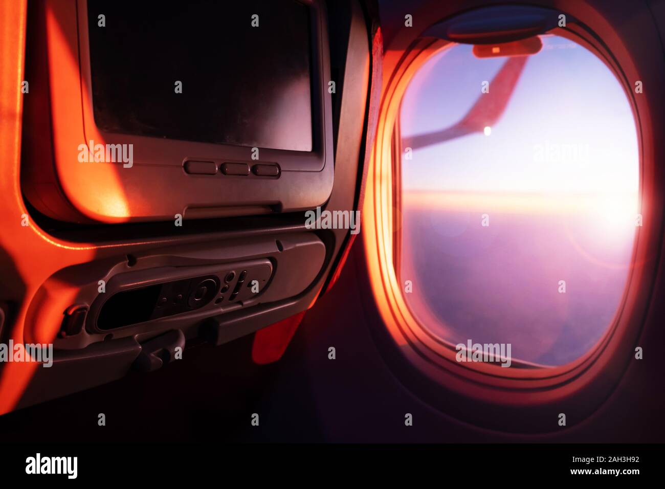 Seats, TV system and window inside an aircraft. Airplane interior in ...