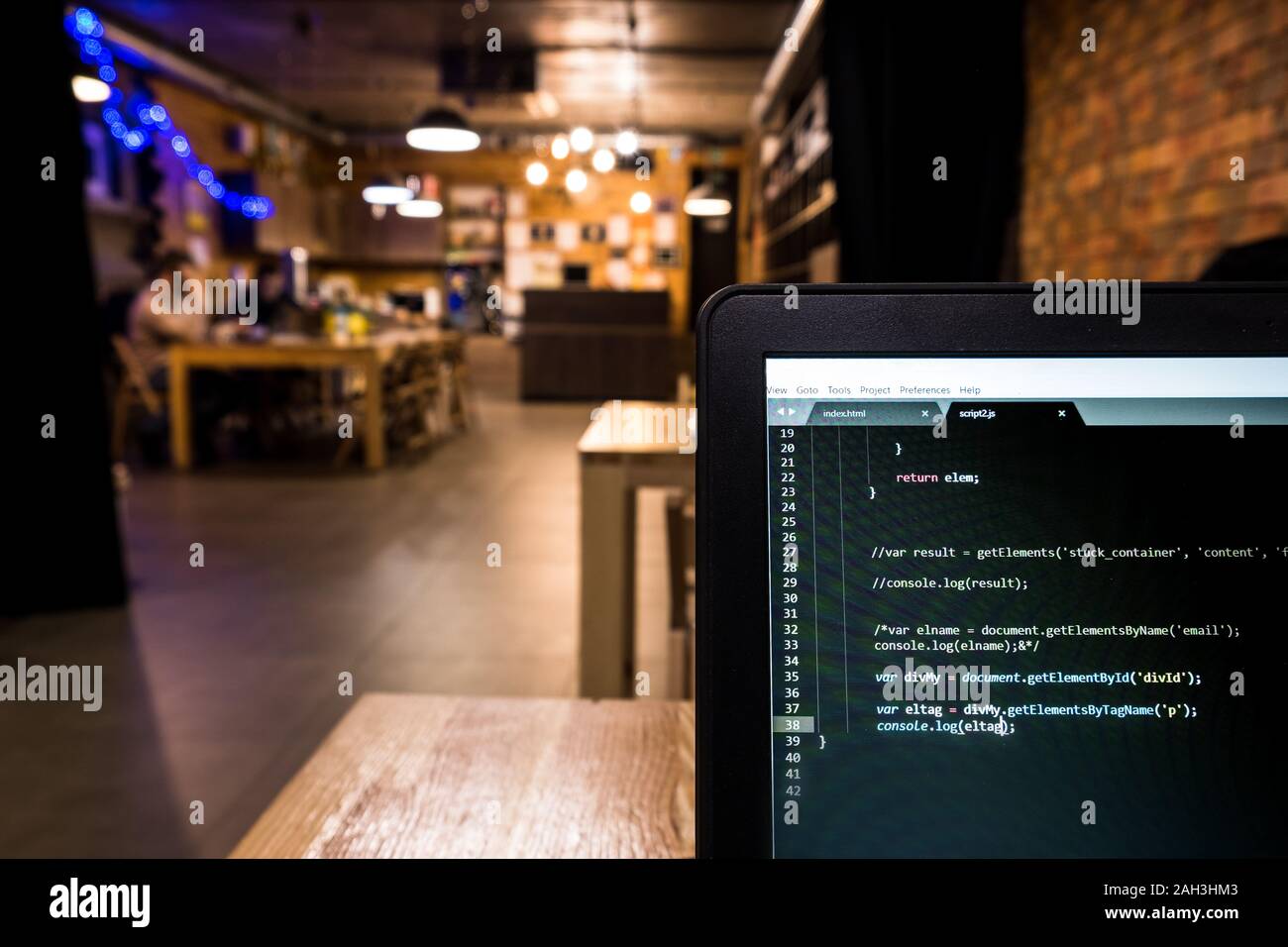 Laptop with programming code in office desk. Low depth of field Stock ...