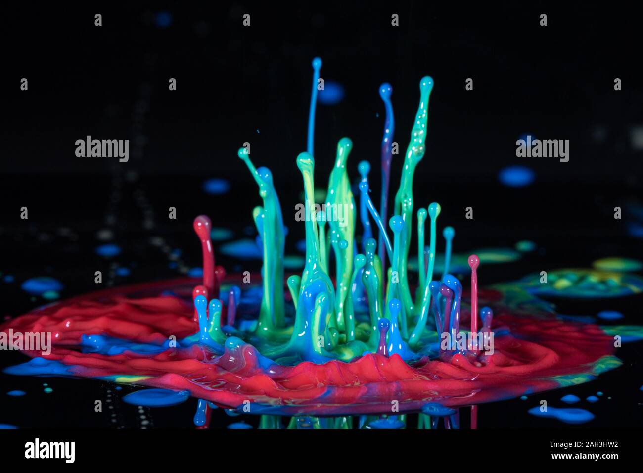 Color ink splash on a black background Stock Photo - Alamy