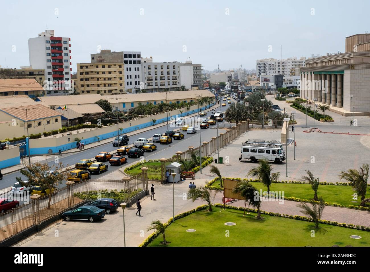 Yellow taxi cabs drive along a road in Dakar, the capital of Senegal ...