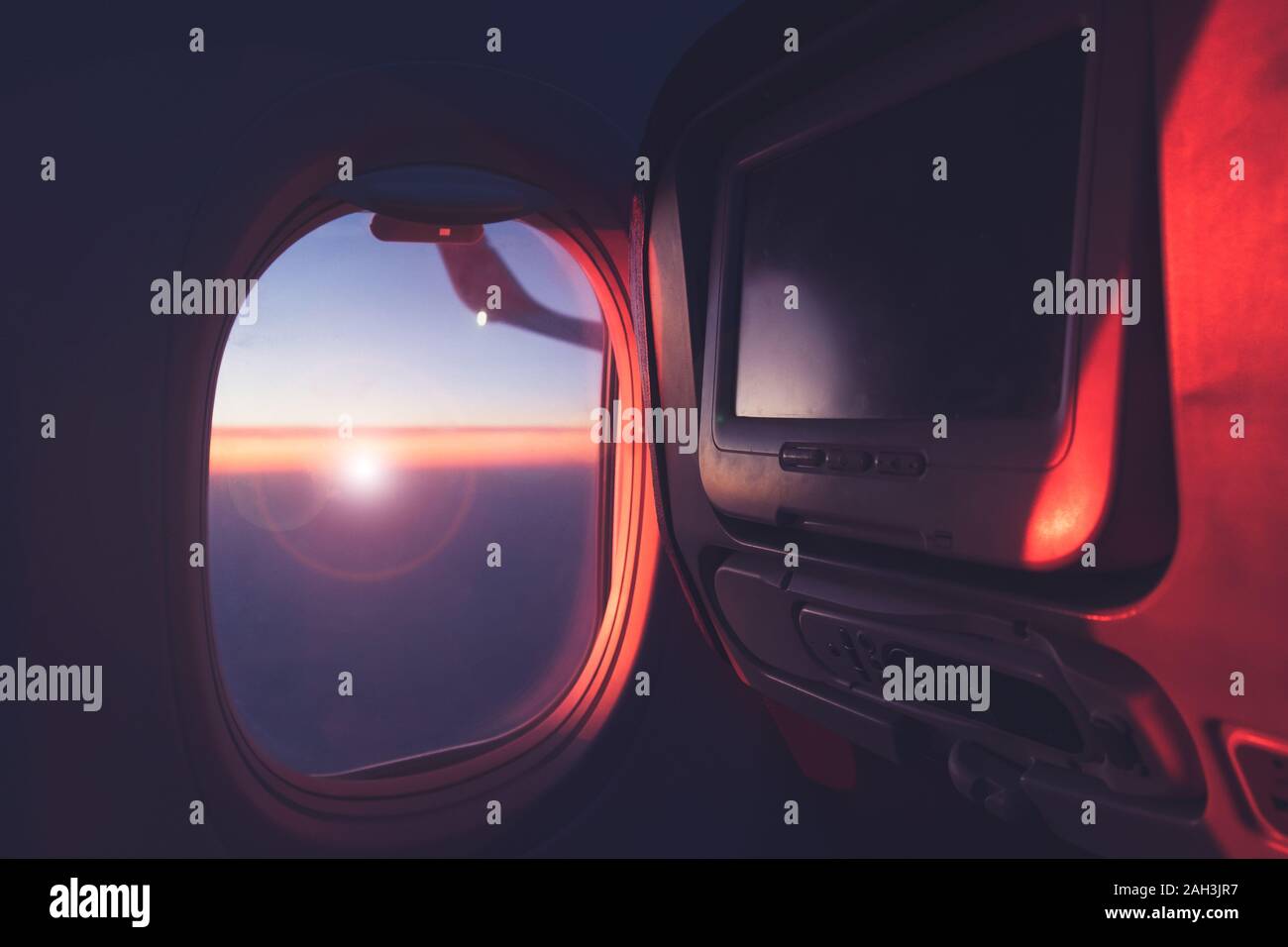 Seats, TV system and window inside an aircraft. Airplane interior in ...