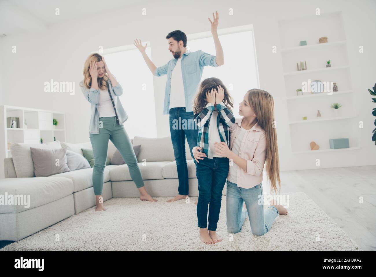 Young family two children avoid parents quarrel tired hear yelling ...