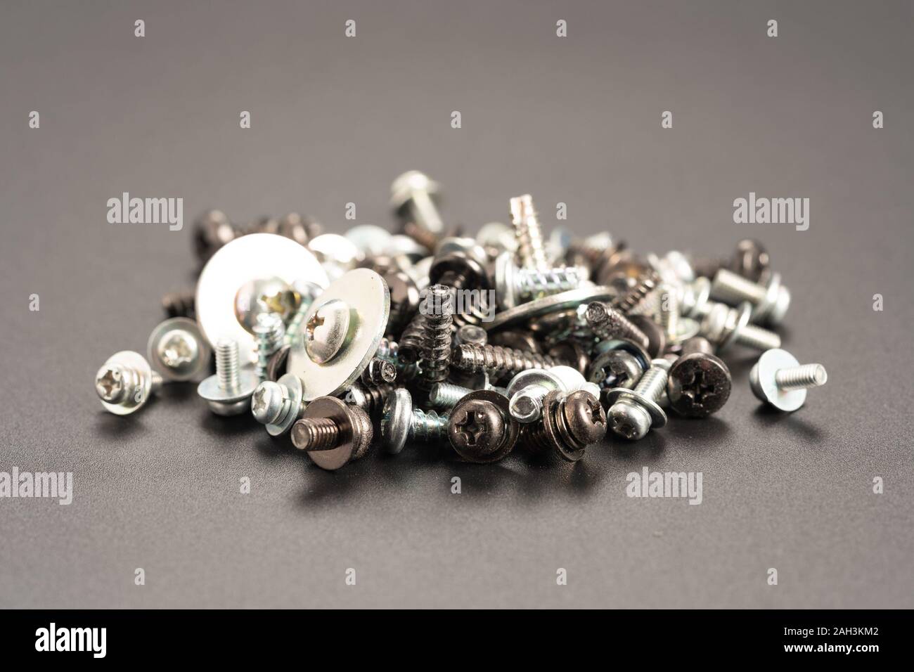 Screws and bolts fasteners industrial black background Stock Photo - Alamy