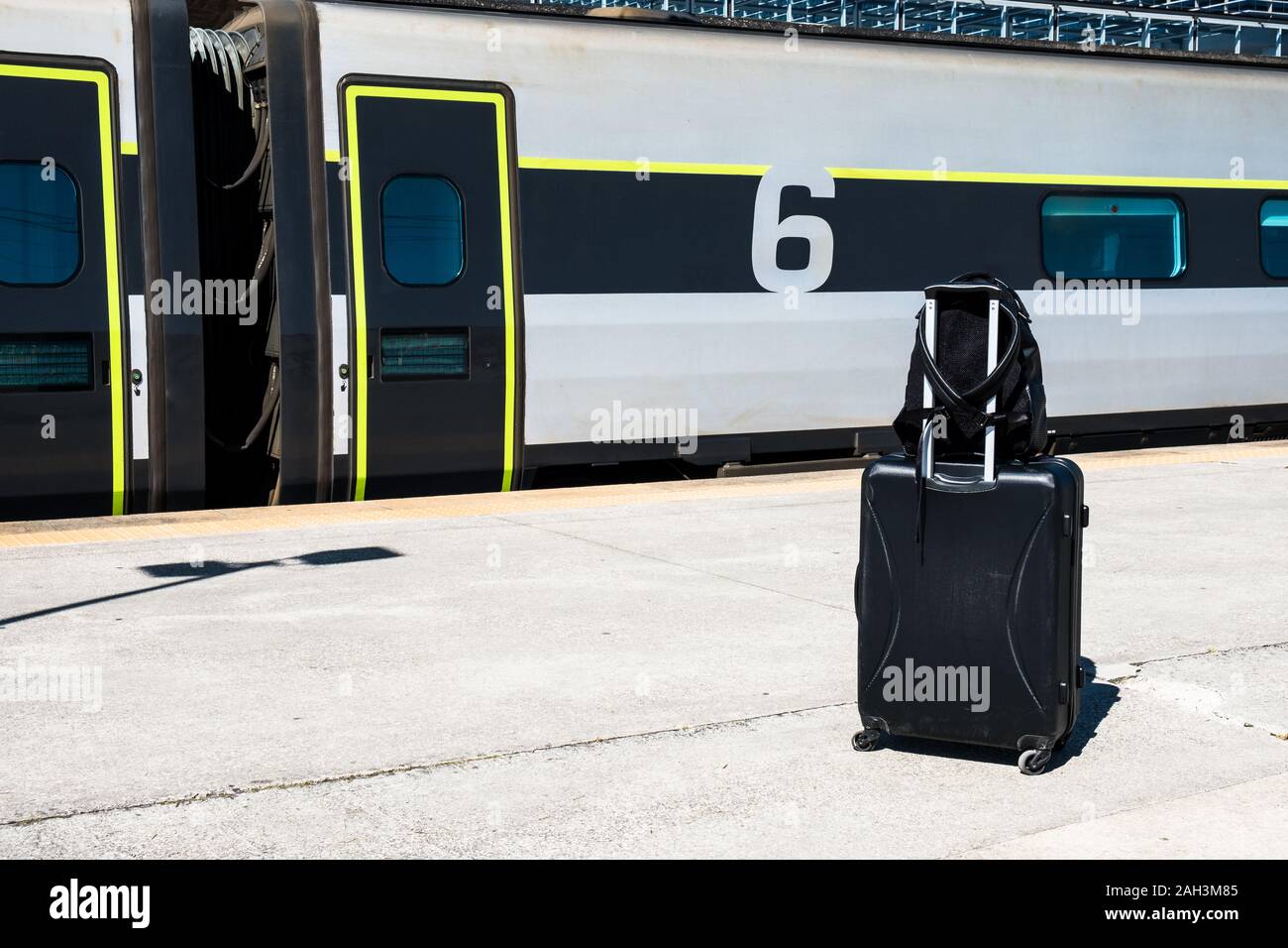 Backpack and suitcase with wheels at the train station. Baggage while ...