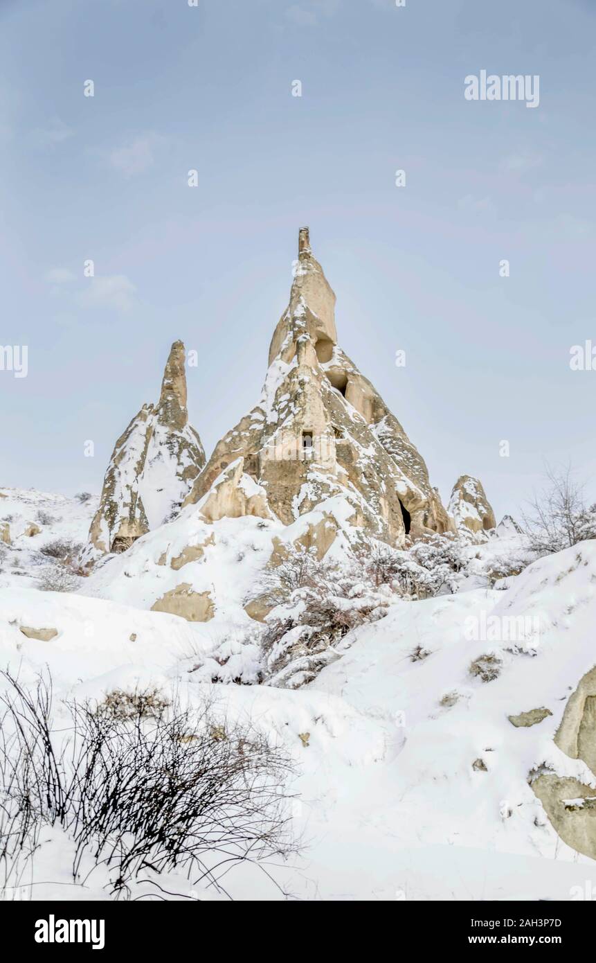 Panorama of unique geological rock formations under snow in Cappadocia ...