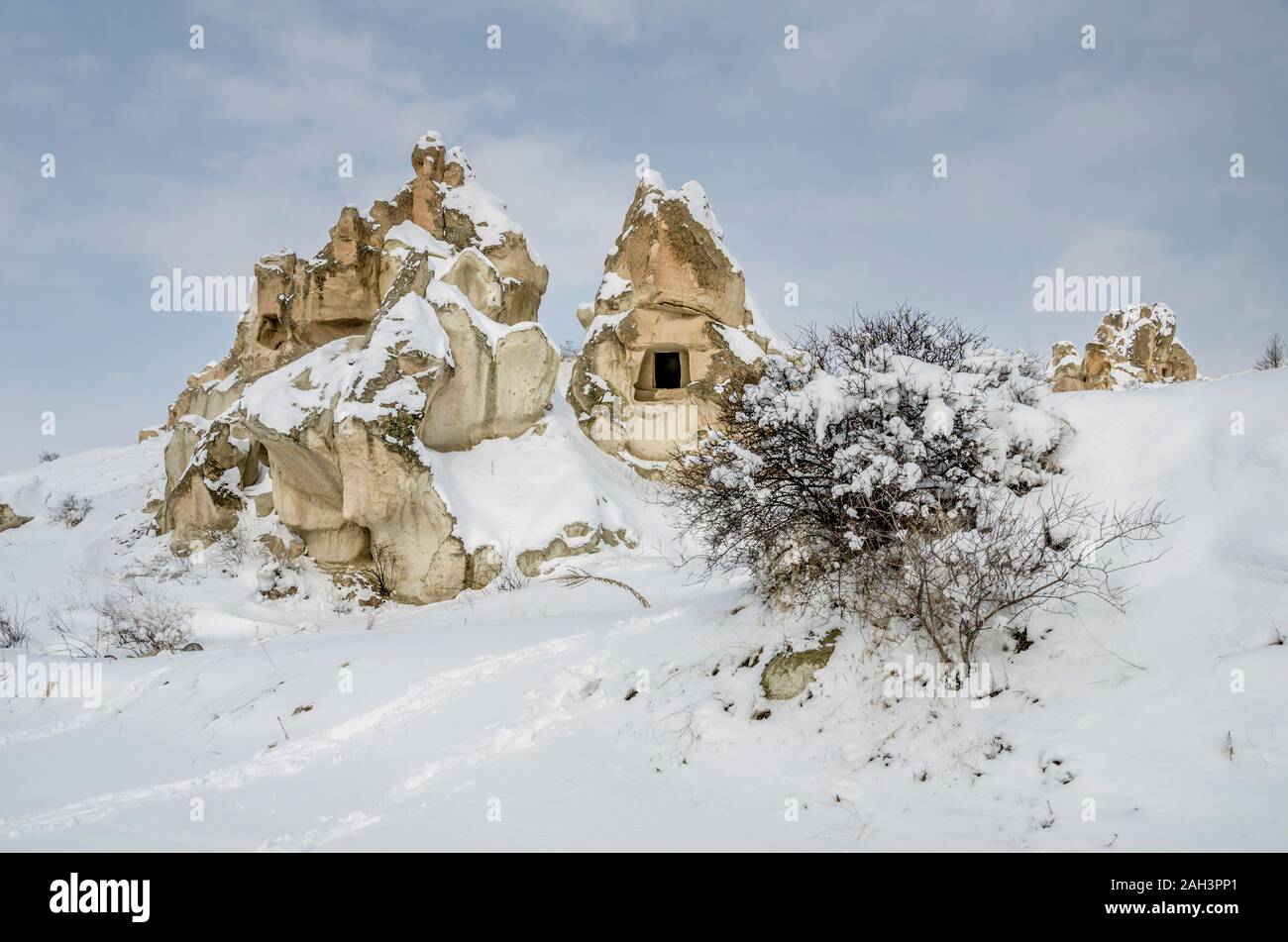 Panorama of unique geological rock formations under snow in Cappadocia ...