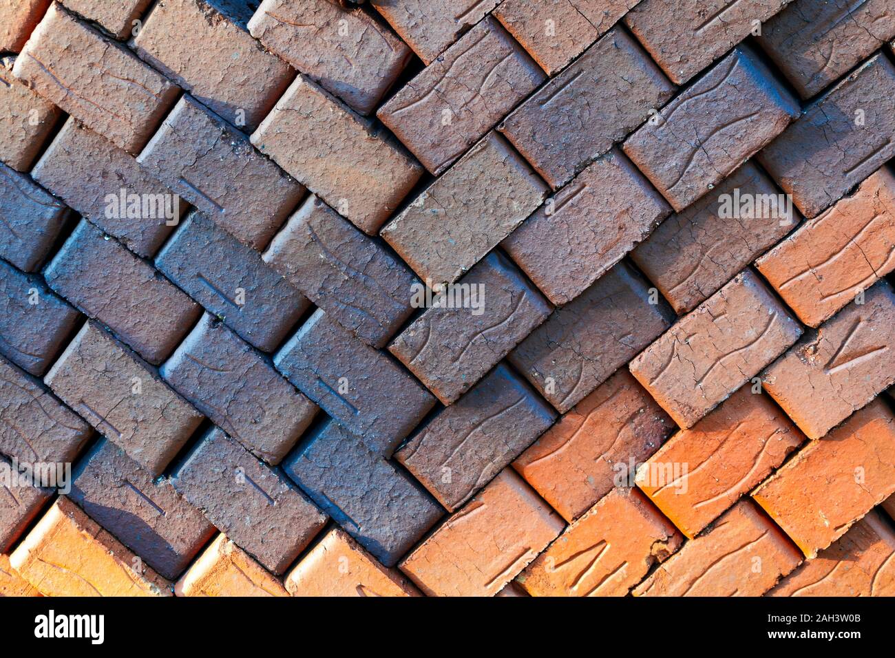 Pile of stacked new red bricks. Clay brick blocks ready for ...