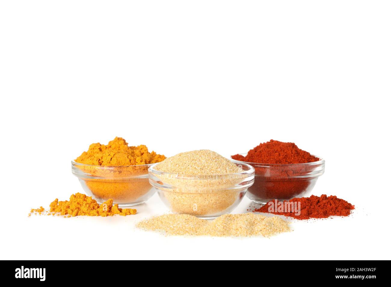 Bowls with red pepper, turmeric and garlic powder isolated on white ...