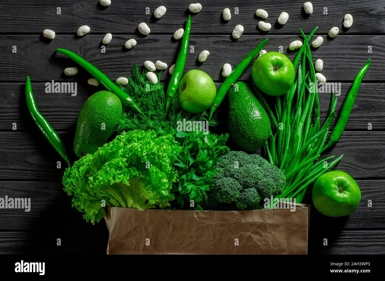Zero waste concept. Paper bag with various green vegetables top view ...
