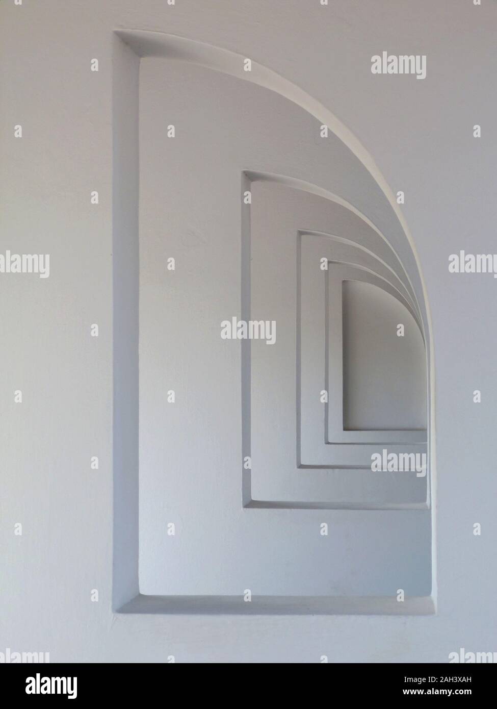 semi arched window openings in stucco finished white walls. diminishing ...