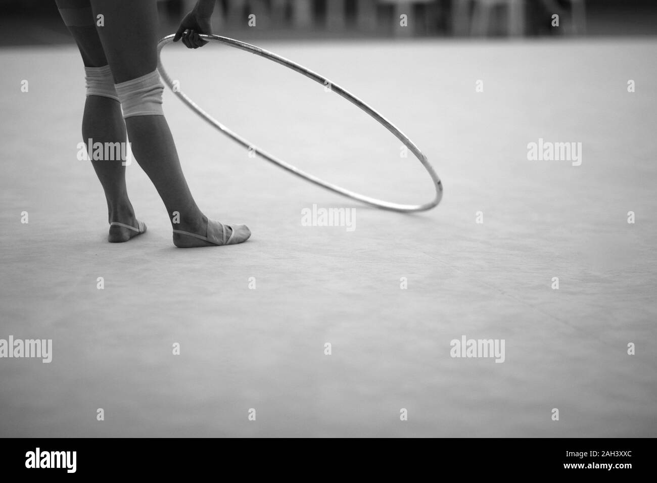 Athlete with a hoop for an exercise in rhythmic gymnastics in a ...