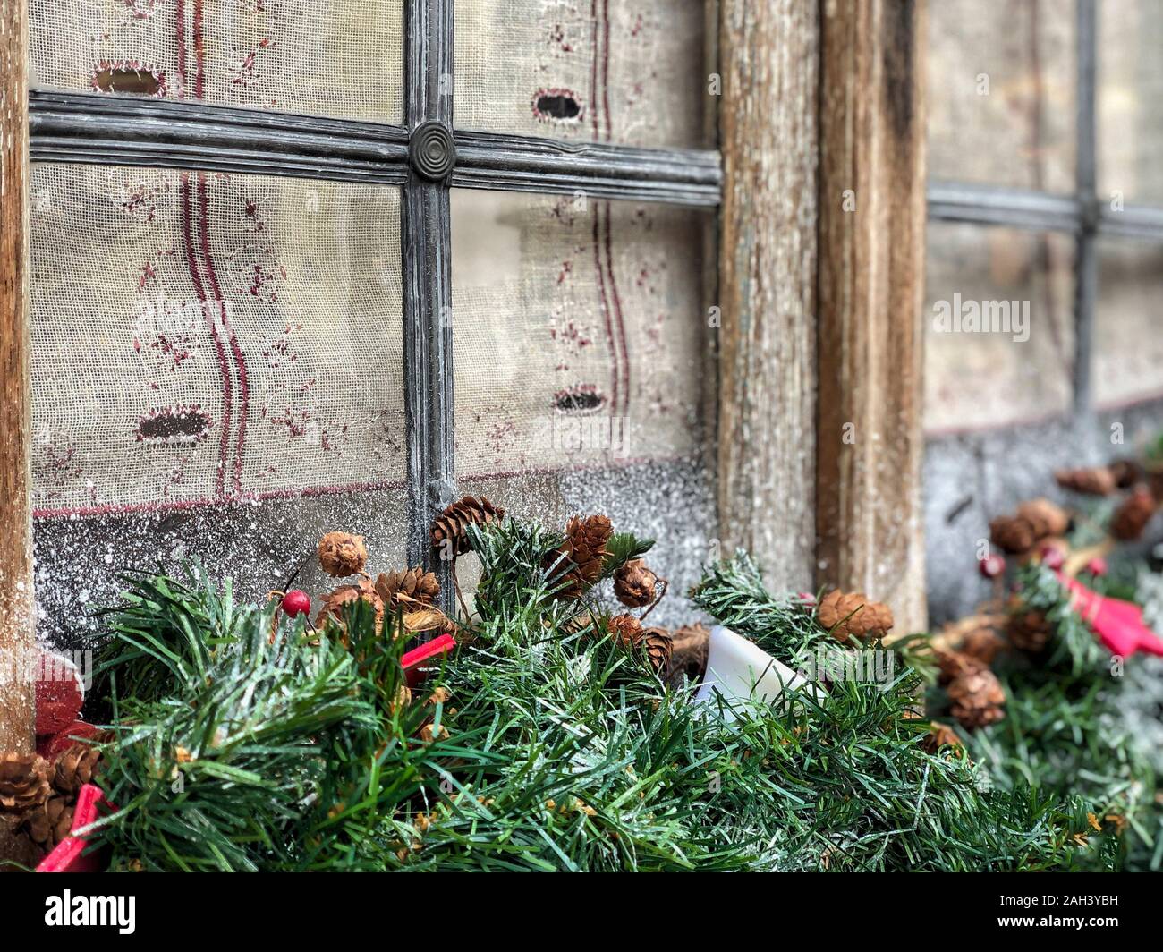 xmas decoration with pine tree branches in front of a window, outdoor ...