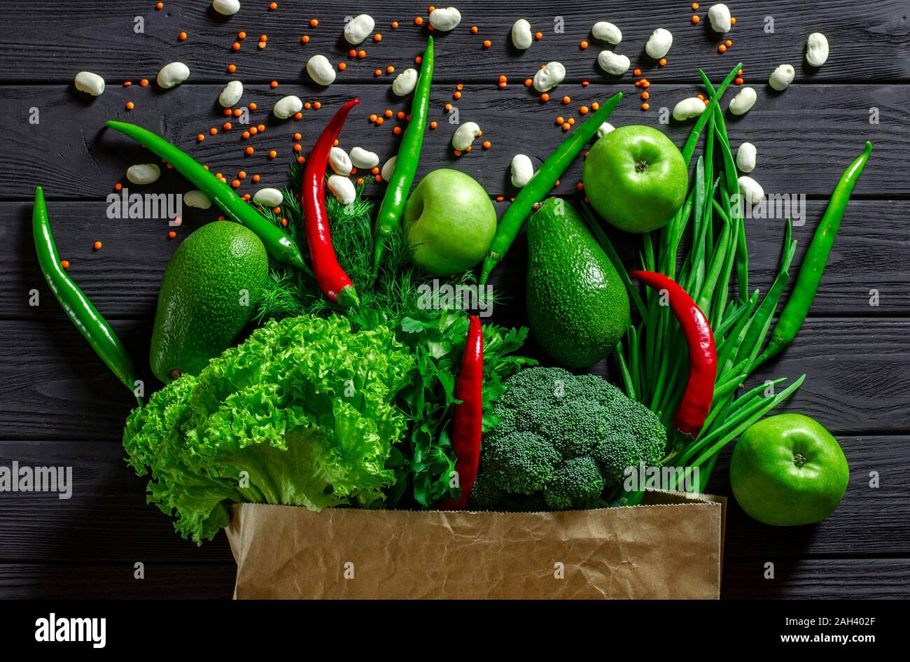 Zero waste concept. Paper bag with various green vegetables top view ...