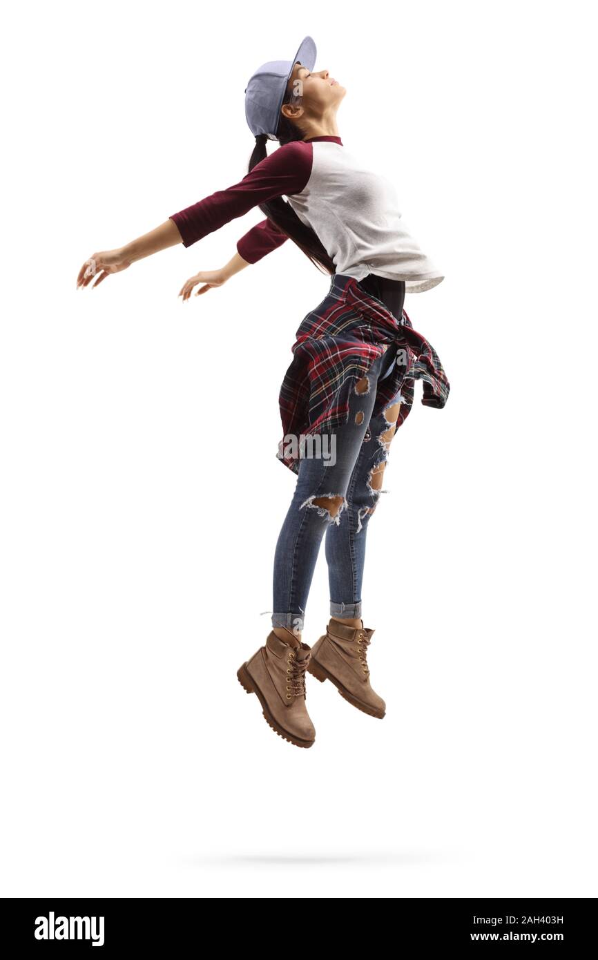 Full length shot of a young woman dancing and performing a jump ...