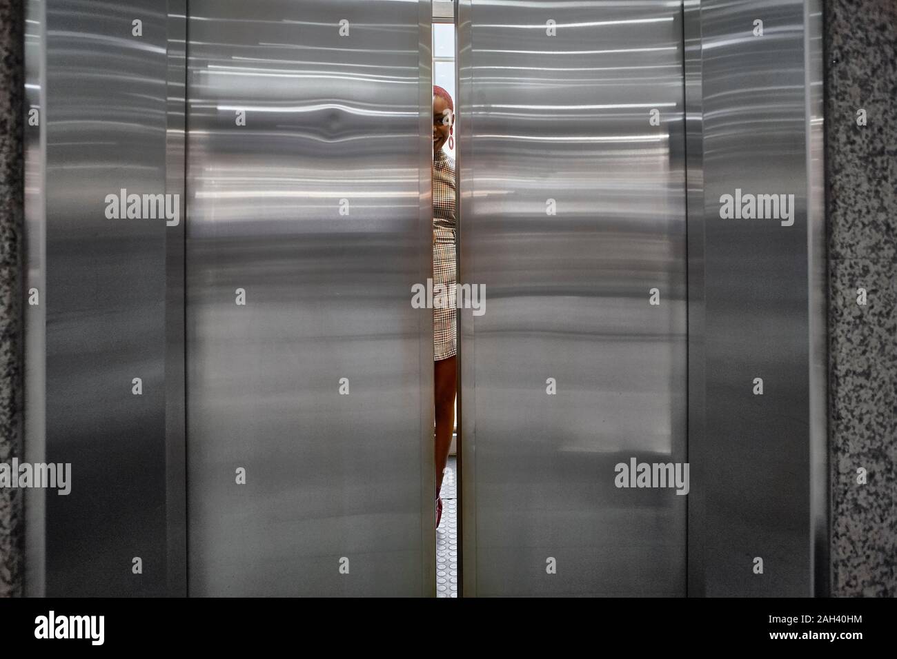 Woman closing door hi-res stock photography and images - Alamy