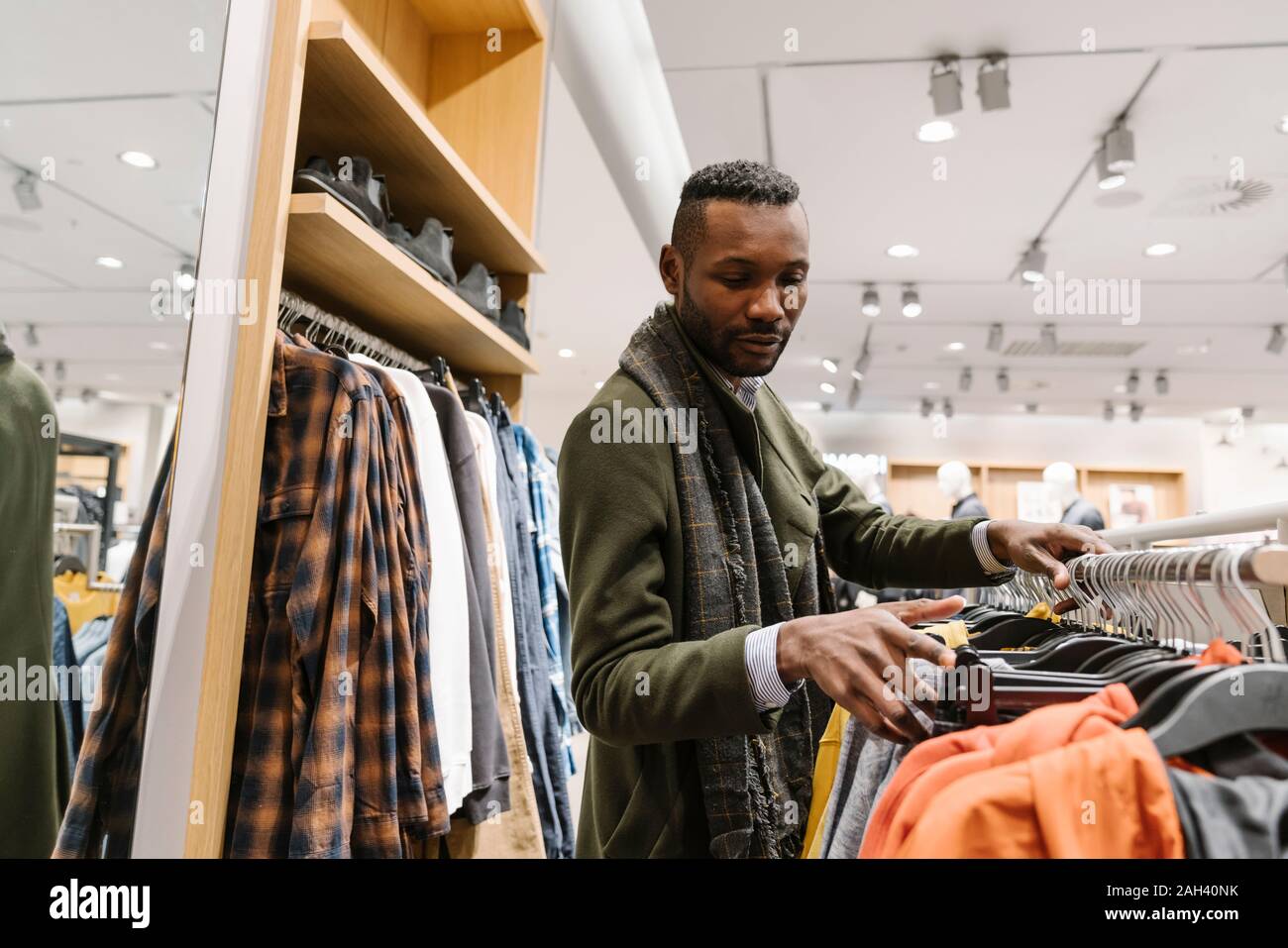 Stylish man shopping in a clothes store Stock Photo - Alamy