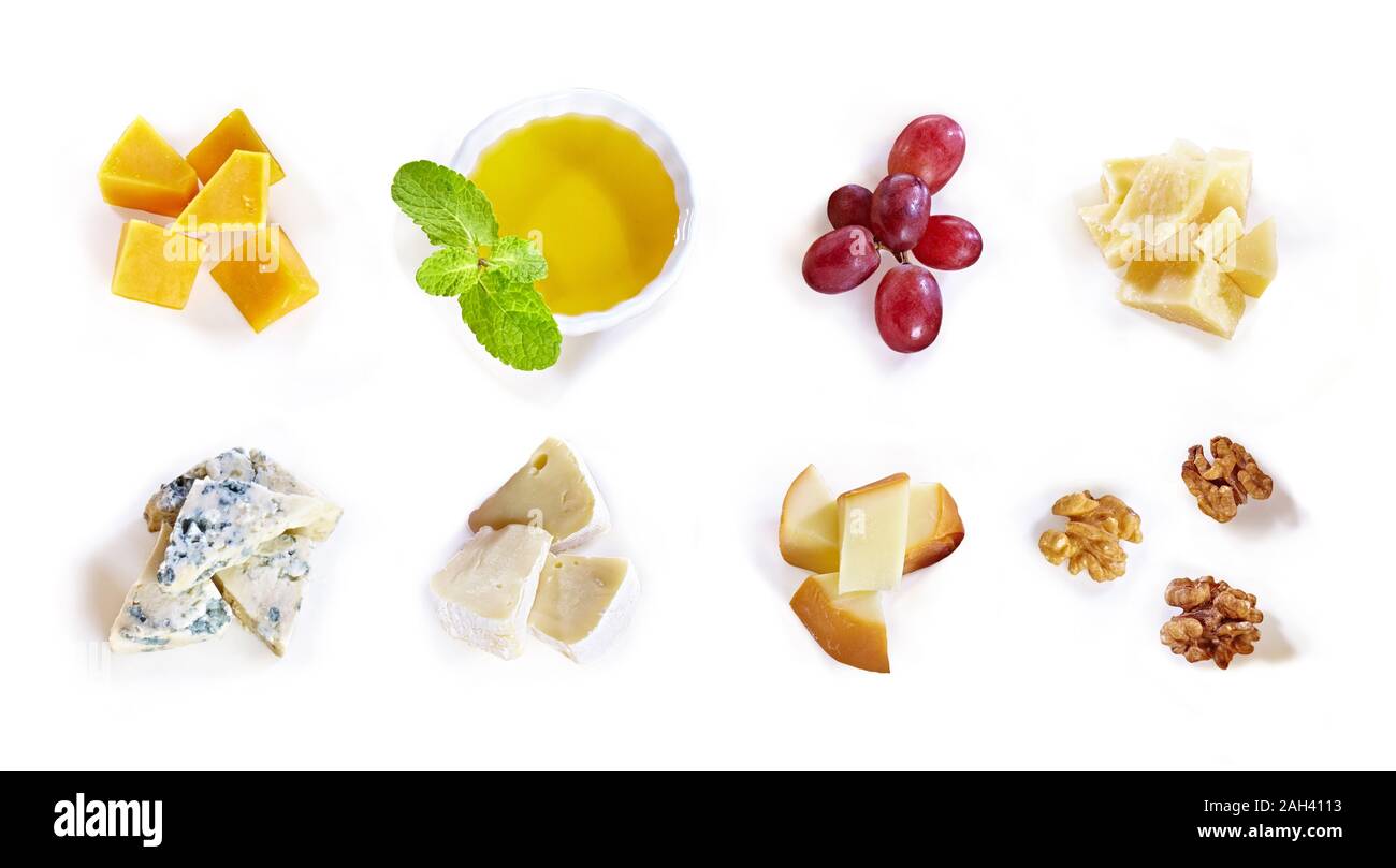 Different type of cheese with honey, grape, nuts on white background ...