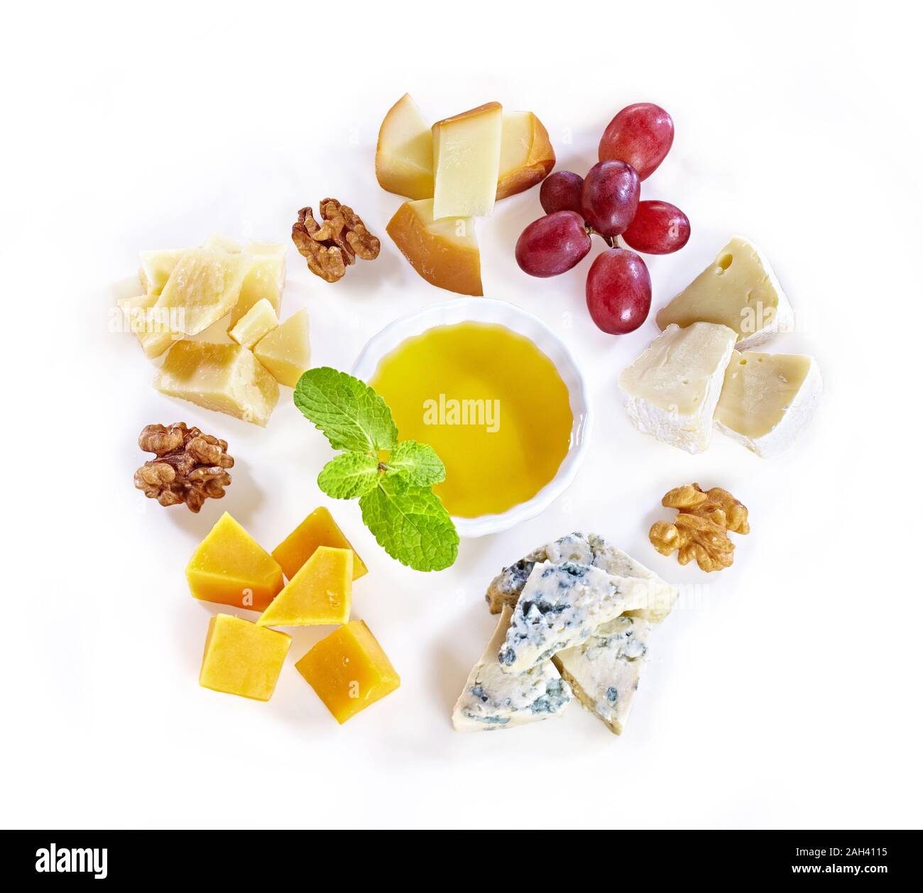 Different type of cheese with honey, grape, nuts on white background ...