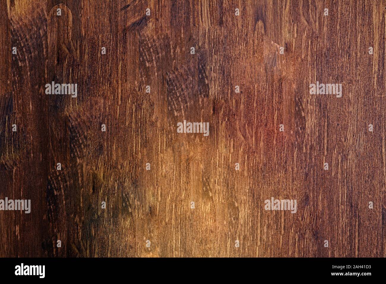 Dark brown wooden table background with light below. Empty rustic old ...