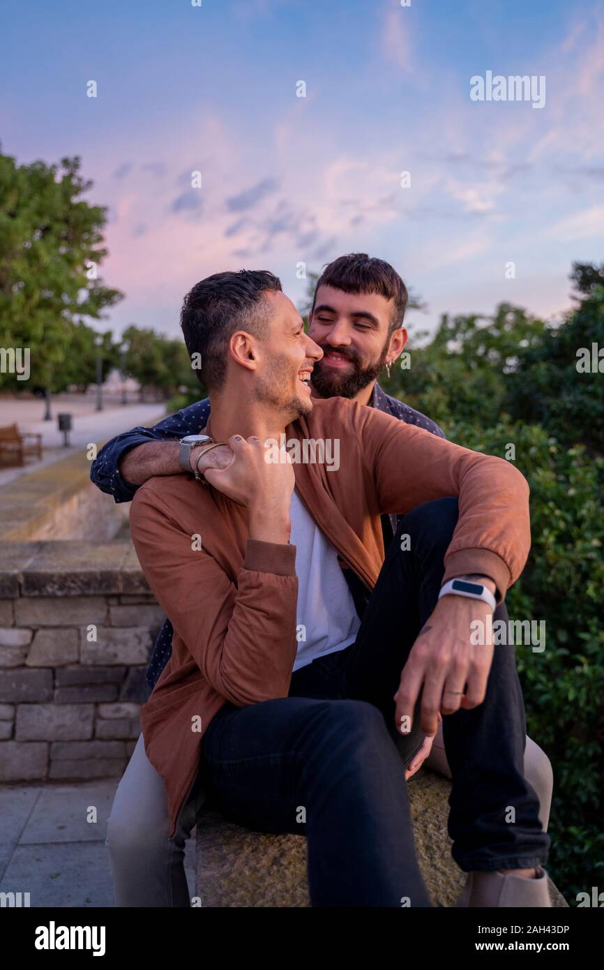 Happy gay couple cuddling hi-res stock photography and images - Alamy