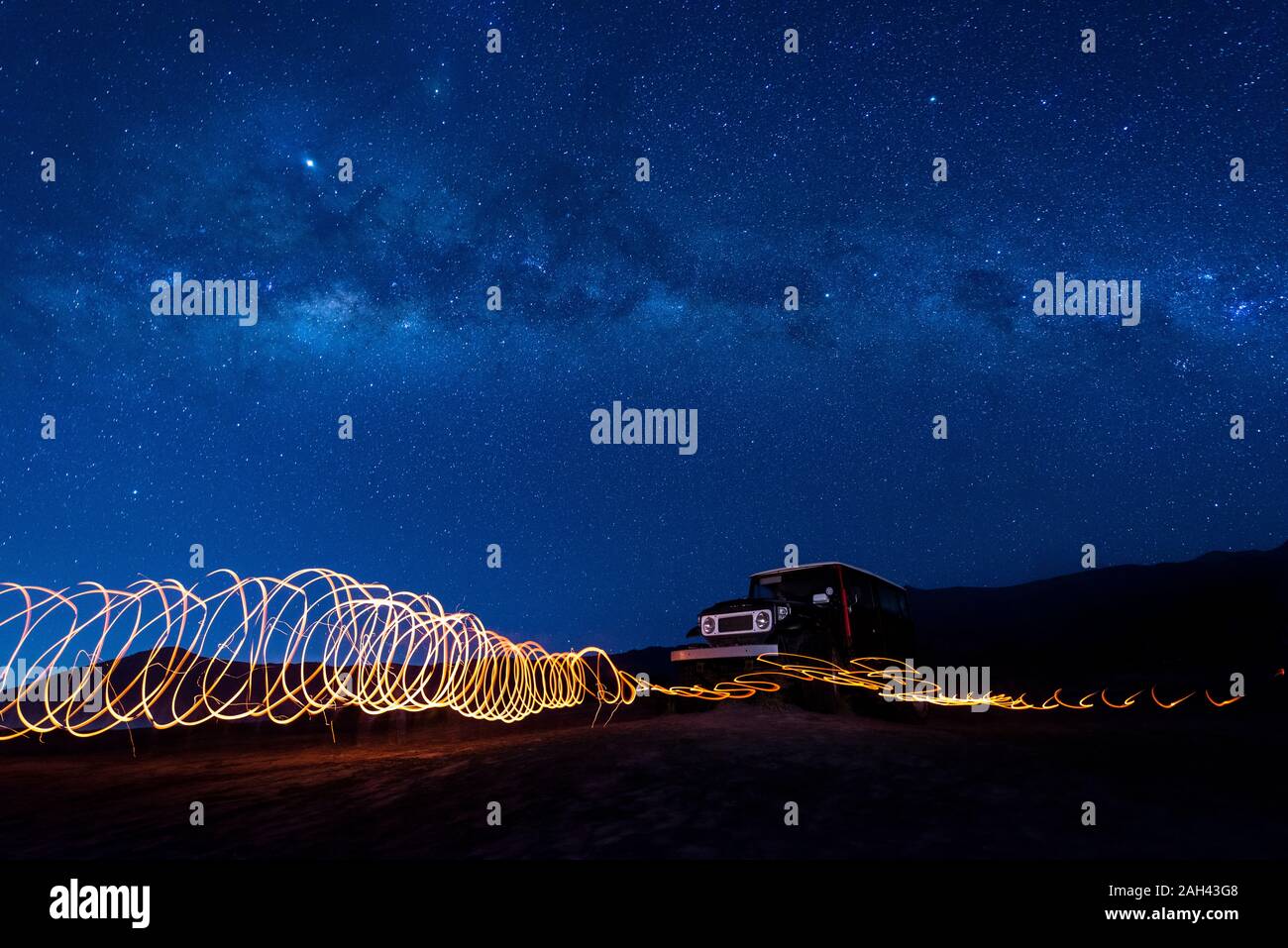 Indonesia, East Java, Spiral light trails in front of car parked in ...