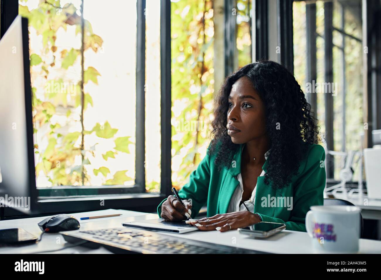businesswoman with drawing tablet in office Stock Photo - Alamy