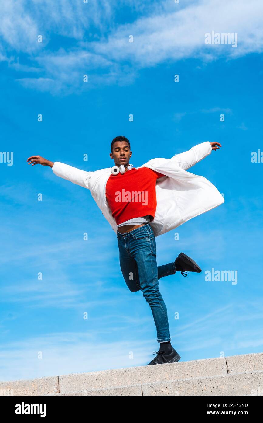 Young man moving and dancing outdoors Stock Photo - Alamy