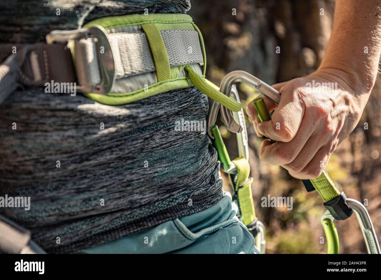 Woman putting climbing harness hi-res stock photography and images - Alamy