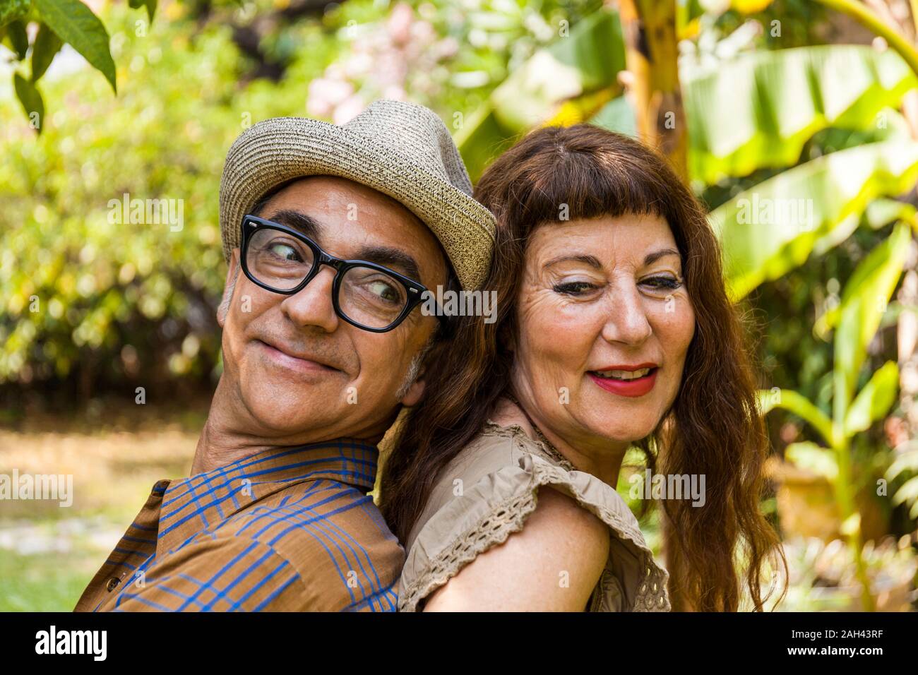Portrait of mature couple, back on back Stock Photo - Alamy