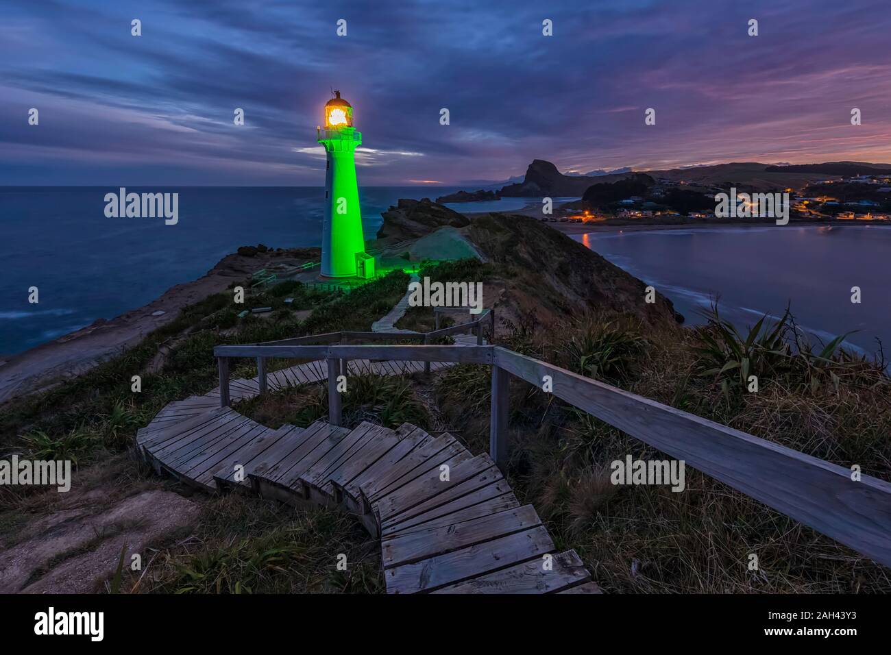 Illuminated lighthouse at dusk, Castlepoint, New Zealand Stock Photo ...