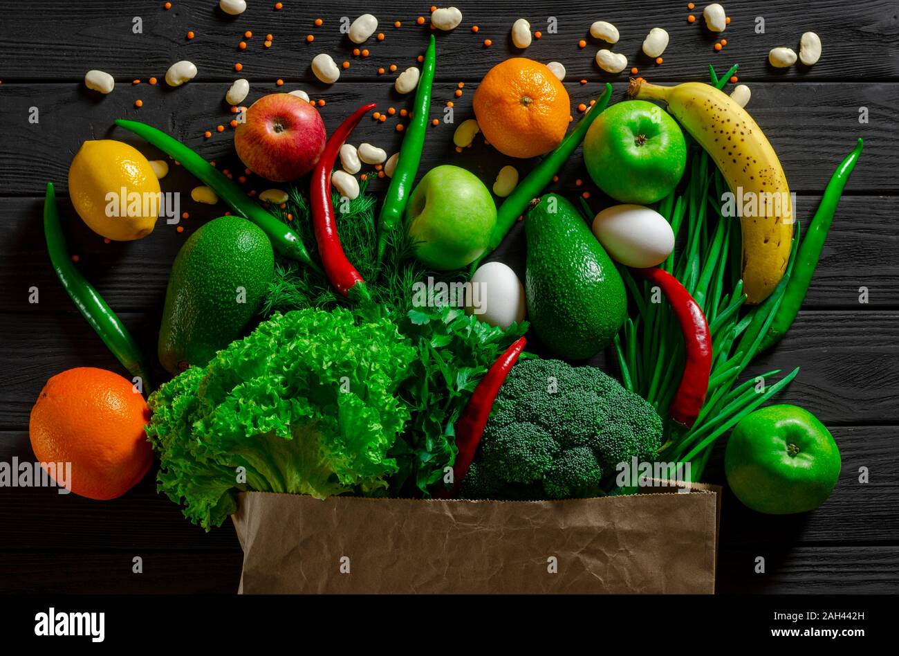 Top view paper bag of different fresh health food on white wooden ...