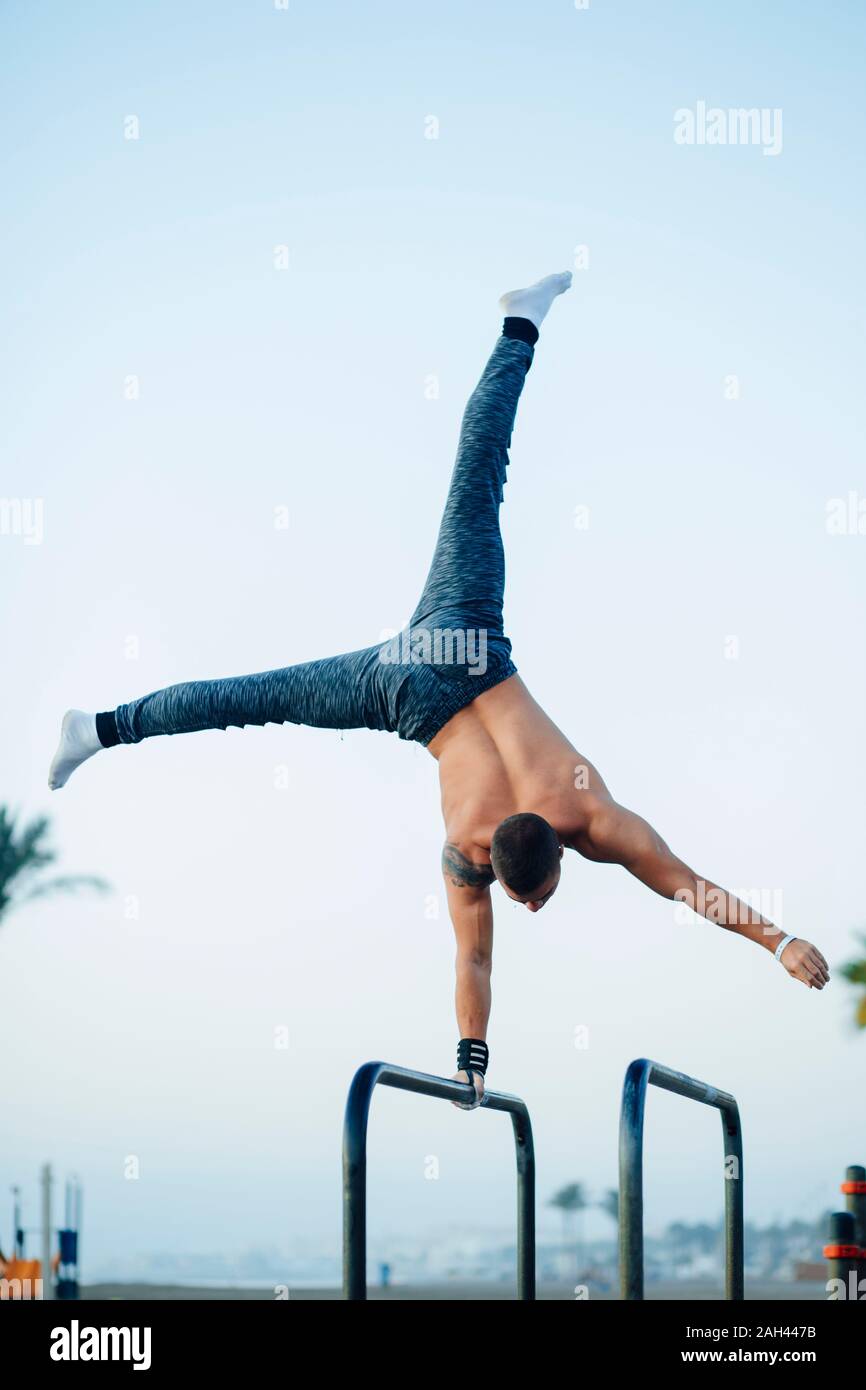 Young man practicing calisthenics at an outdoor gym Stock Photo - Alamy