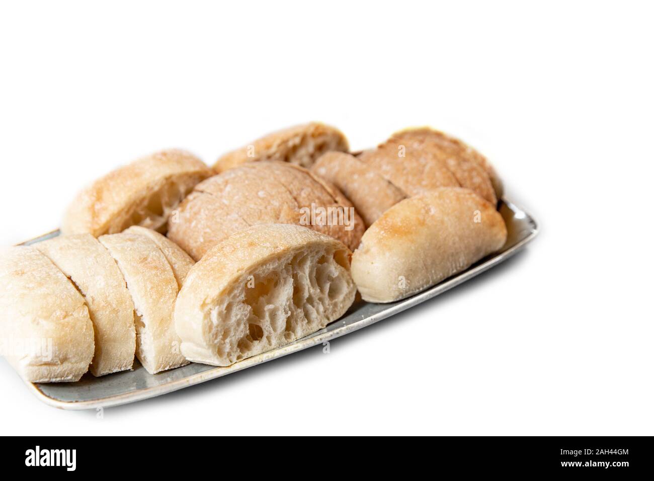 Delicious air bread with crispy crust, cut into pieces, lies on a white ...