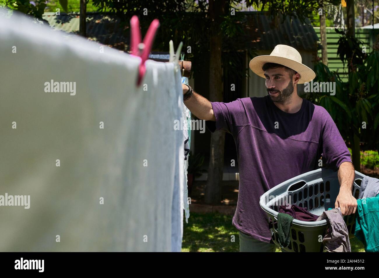 Man hanging up laundry outdoors Stock Photo - Alamy