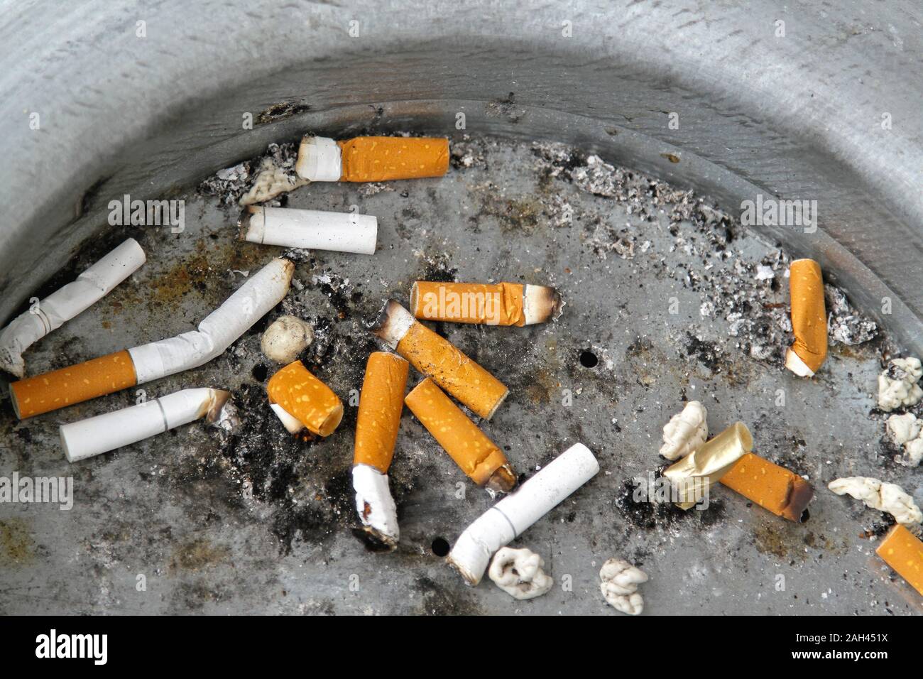 Cigarette butts discarded in ashtray Stock Photo - Alamy