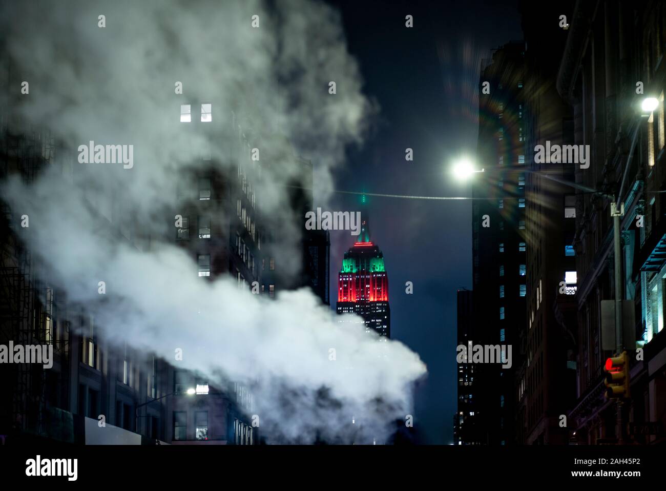 USA, New York, New York City, Smoke floating against illuminated Empire ...