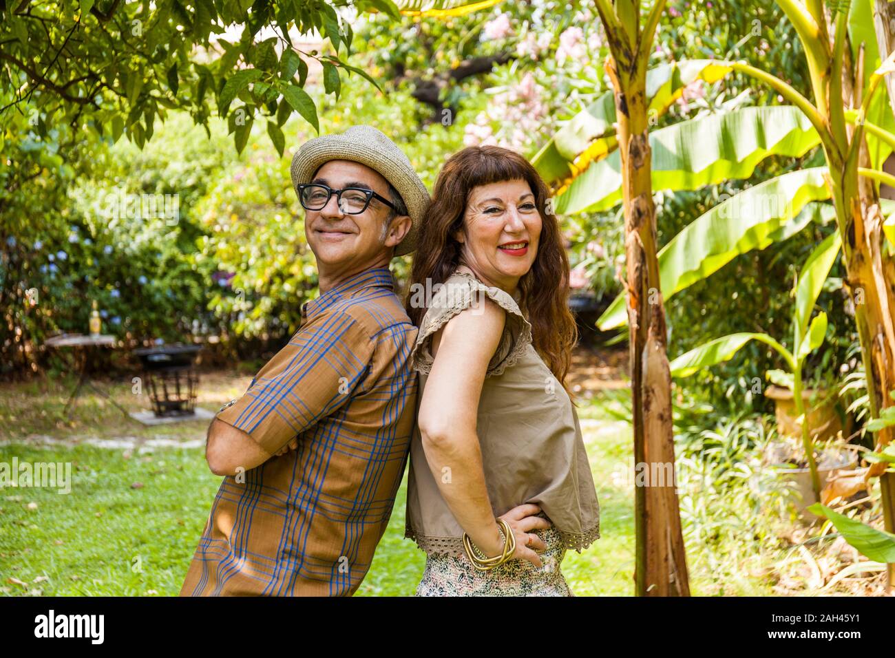 Portrait of mature couple, back on back Stock Photo - Alamy