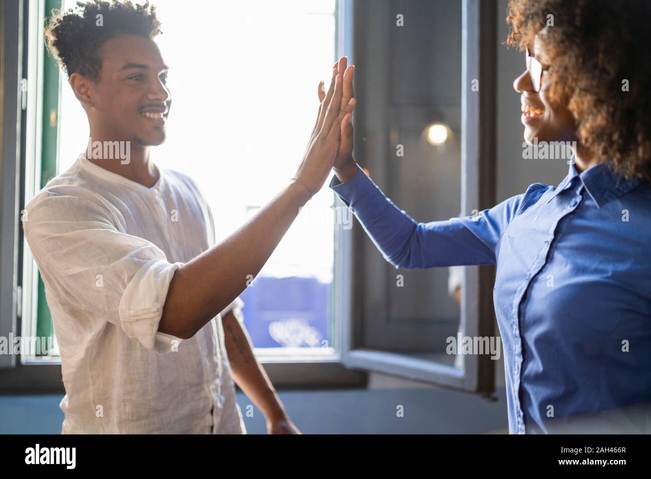 Cheerful female friends high fiving hi-res stock photography and images ...
