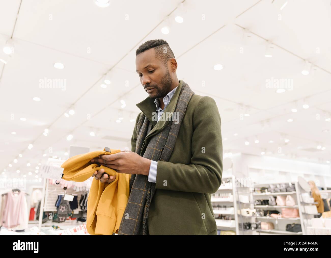 Stylish man shopping in a clothes store Stock Photo - Alamy