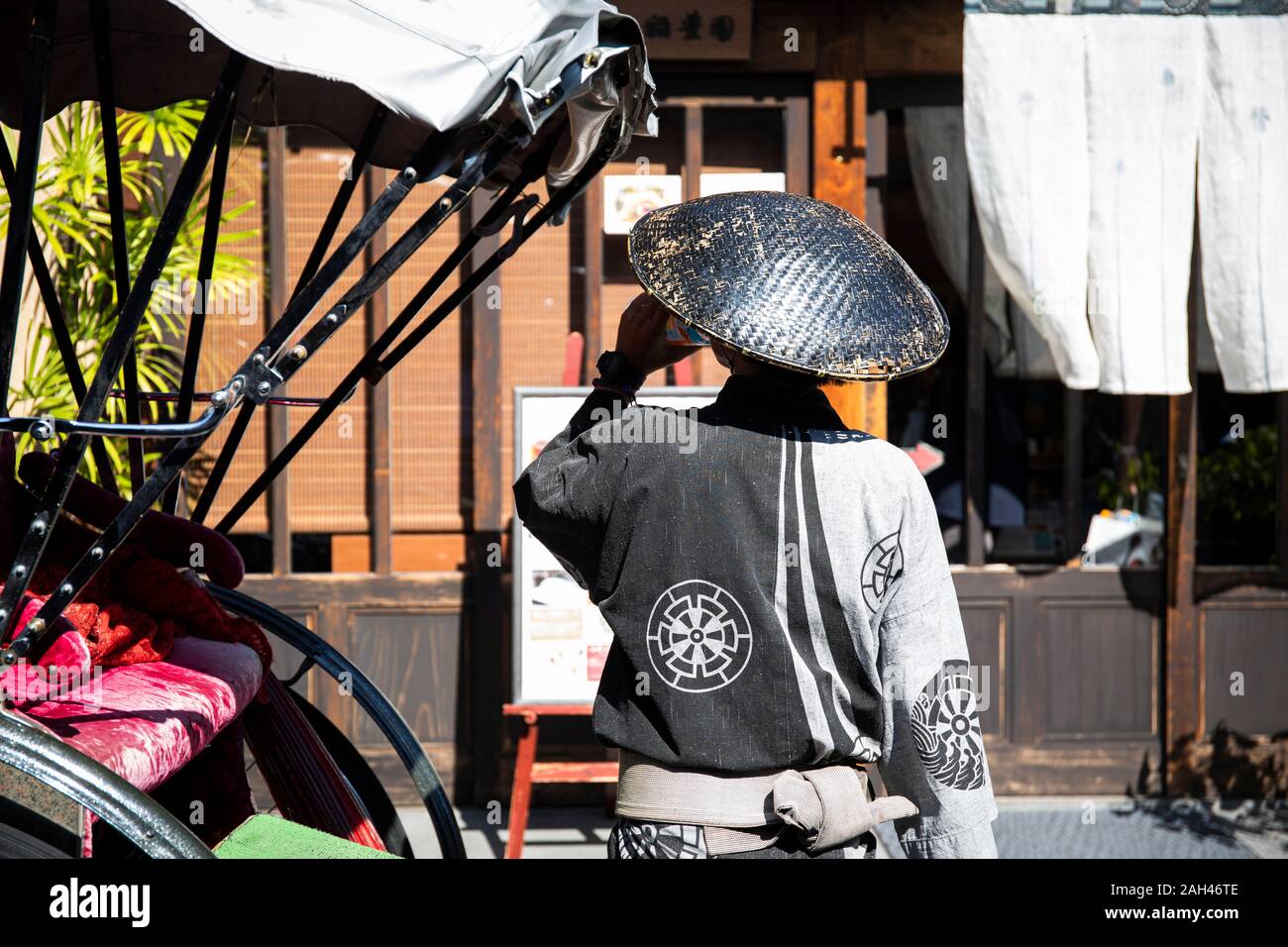 Japan, Takayama, Rear view of jinrikisha driver drinking water Stock ...