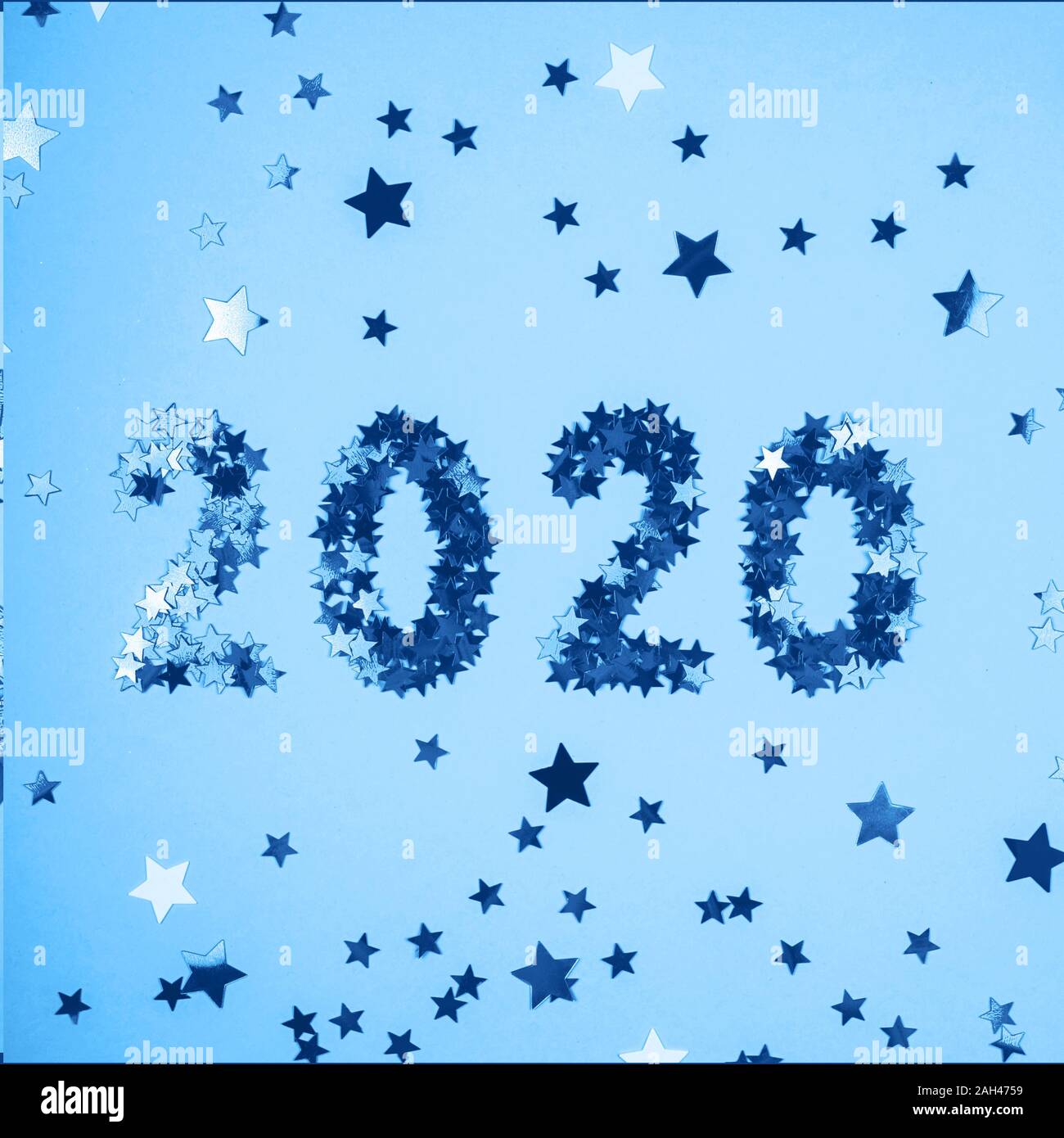 The numbers 2020 are laid out from stars on a bright blue background ...