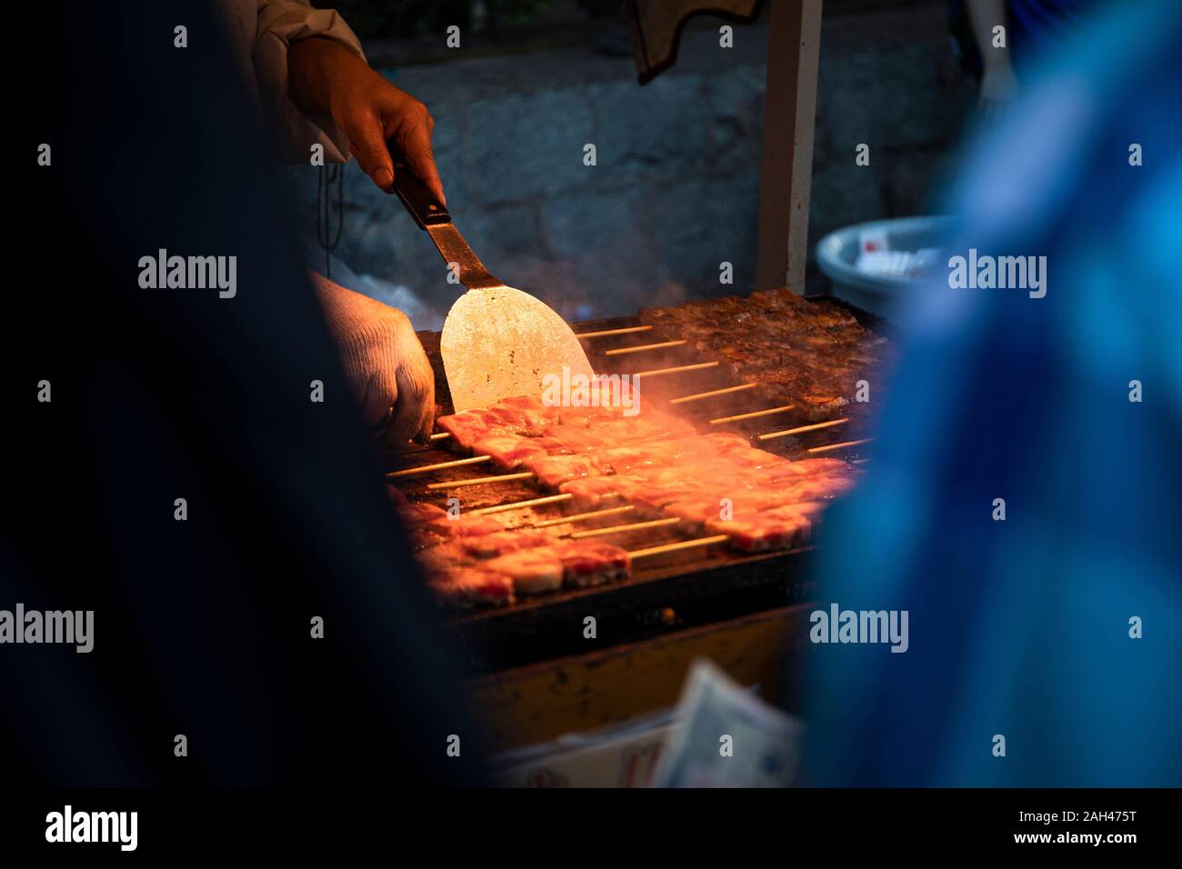 Japan, Kyoto Prefecture, Kyoto City, Hands of chef preparing yakitori ...
