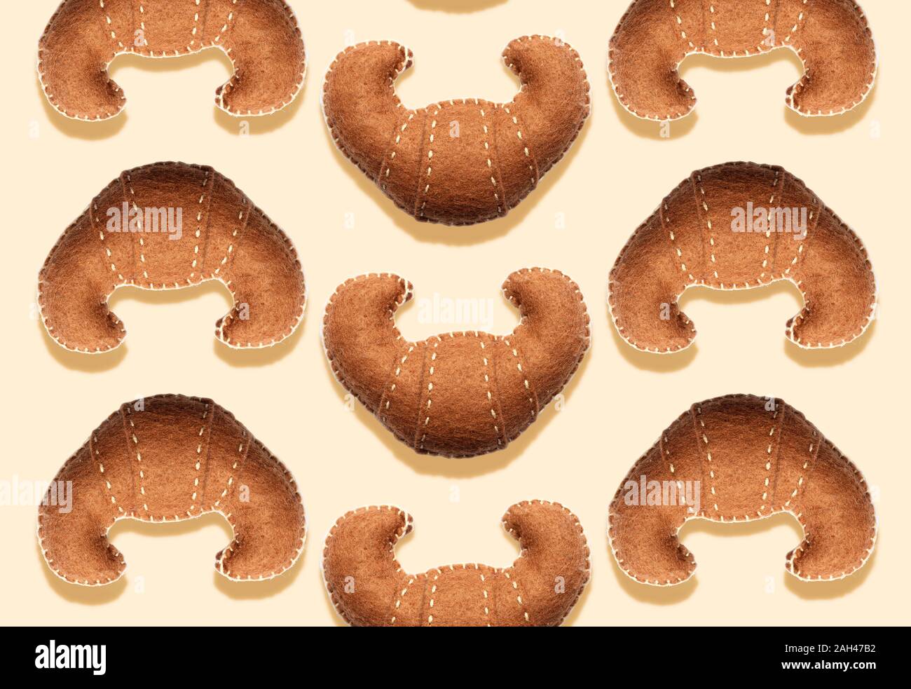 3D Illustration, Plush fake croissants pattern on cream background ...
