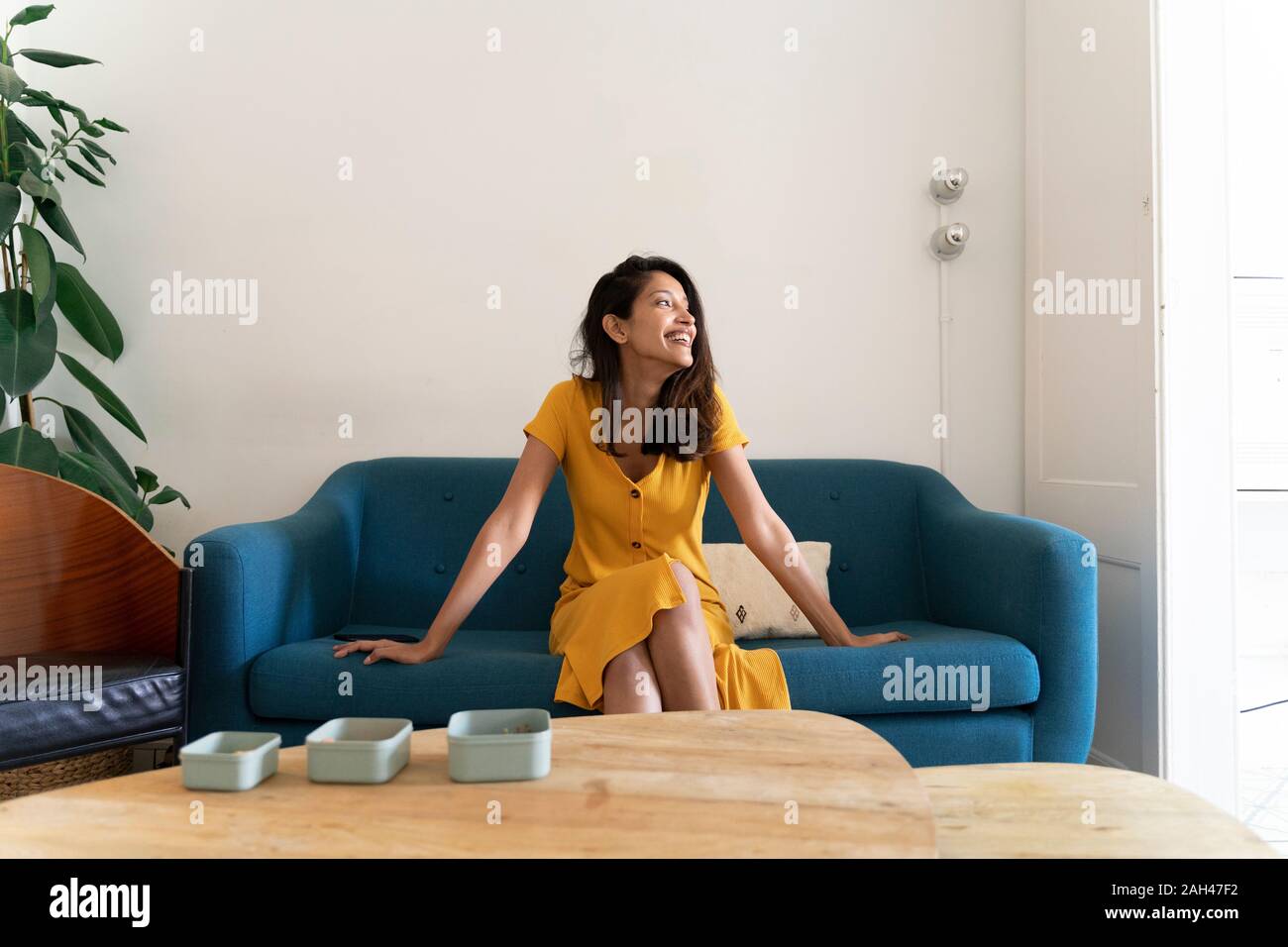Woman Sitting Sideways On Couch High Resolution Stock Photography and ...